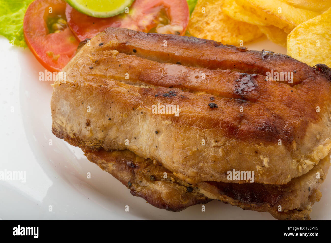 Grilled pork with potato chips Stock Photo - Alamy