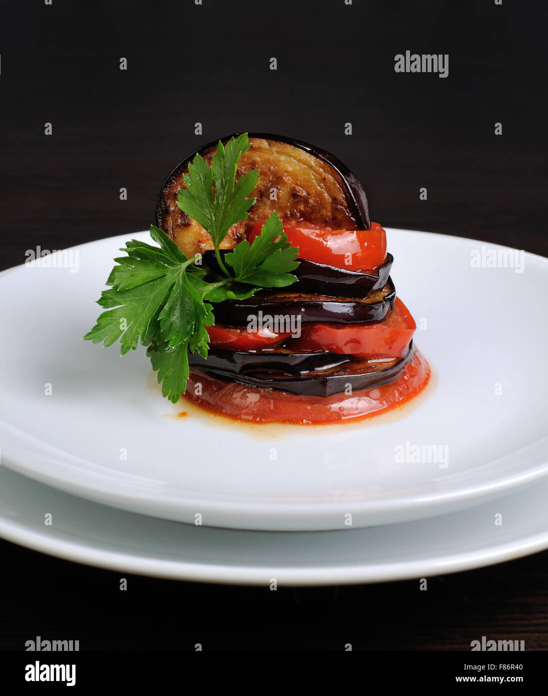 Appetizer of fried eggplant with tomatoes, parsley Stock Photo - Alamy