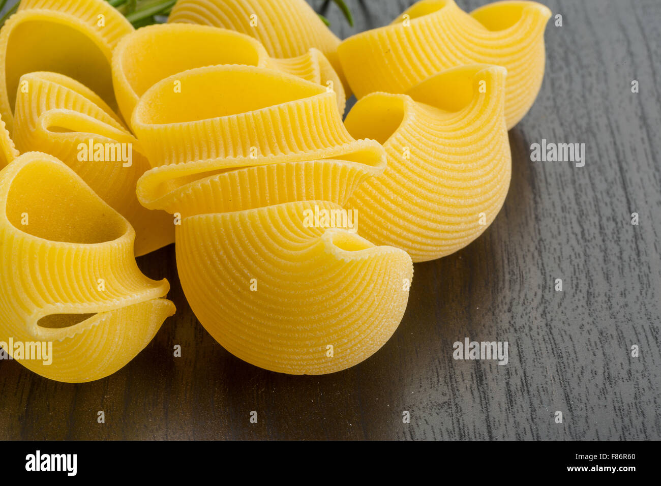 Raw shell pasta with herbs Stock Photo - Alamy
