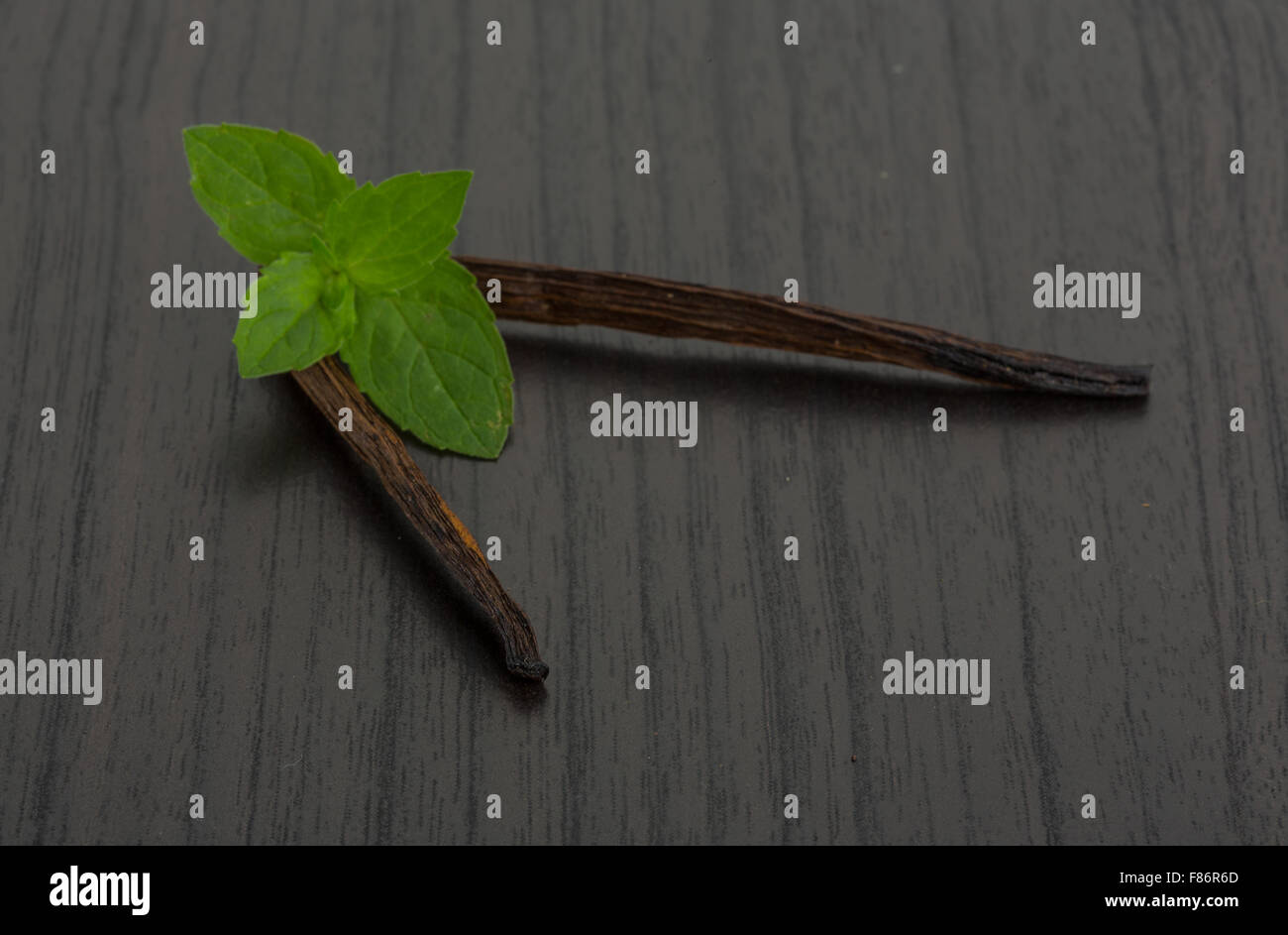 Vanilla with mint leaf on the board Stock Photo - Alamy