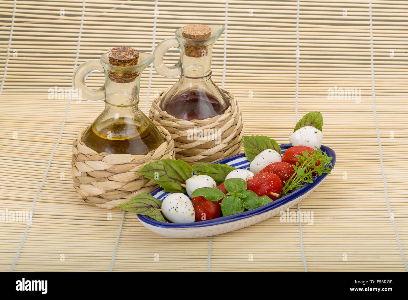 Famous italian caprese salad with fresh basil leaves Stock Photo - Alamy
