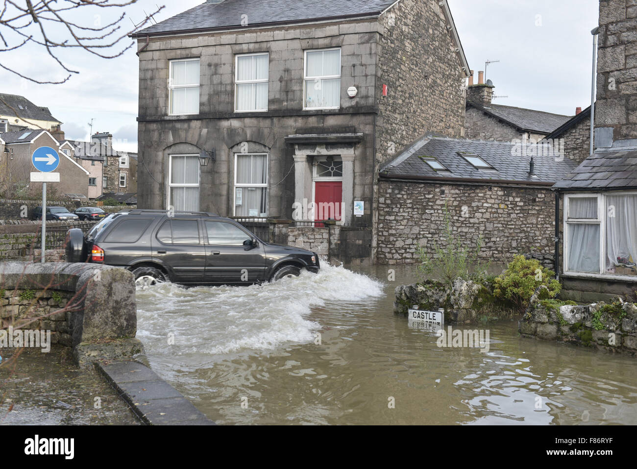 Kendal, UK. 06th Dec, 2015. A 4x4 drives through the flood water on ...