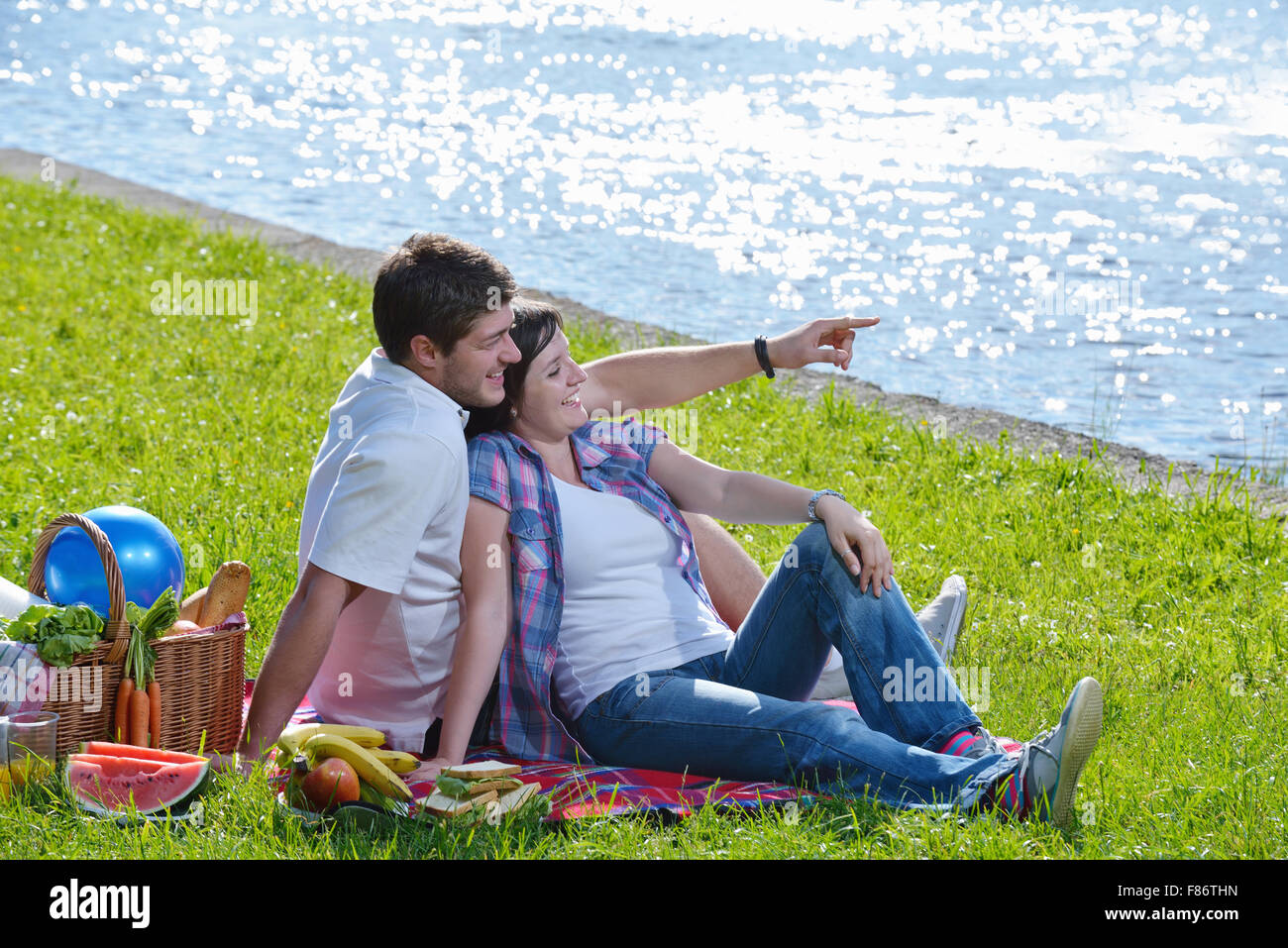 happy young romantic couple in love having a picnic outdoor on a summer ...