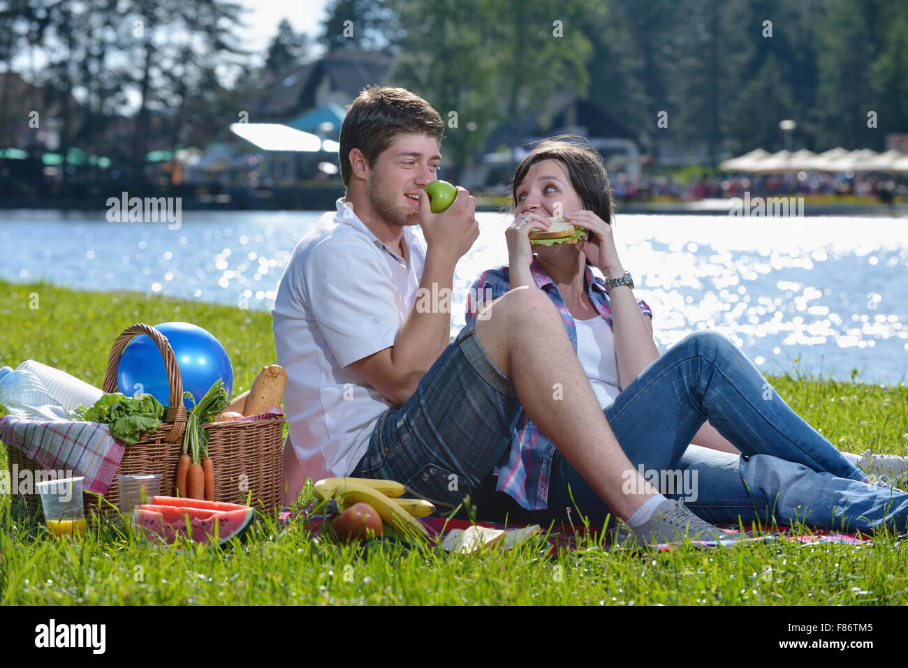 happy young romantic couple in love having a picnic outdoor on a summer ...
