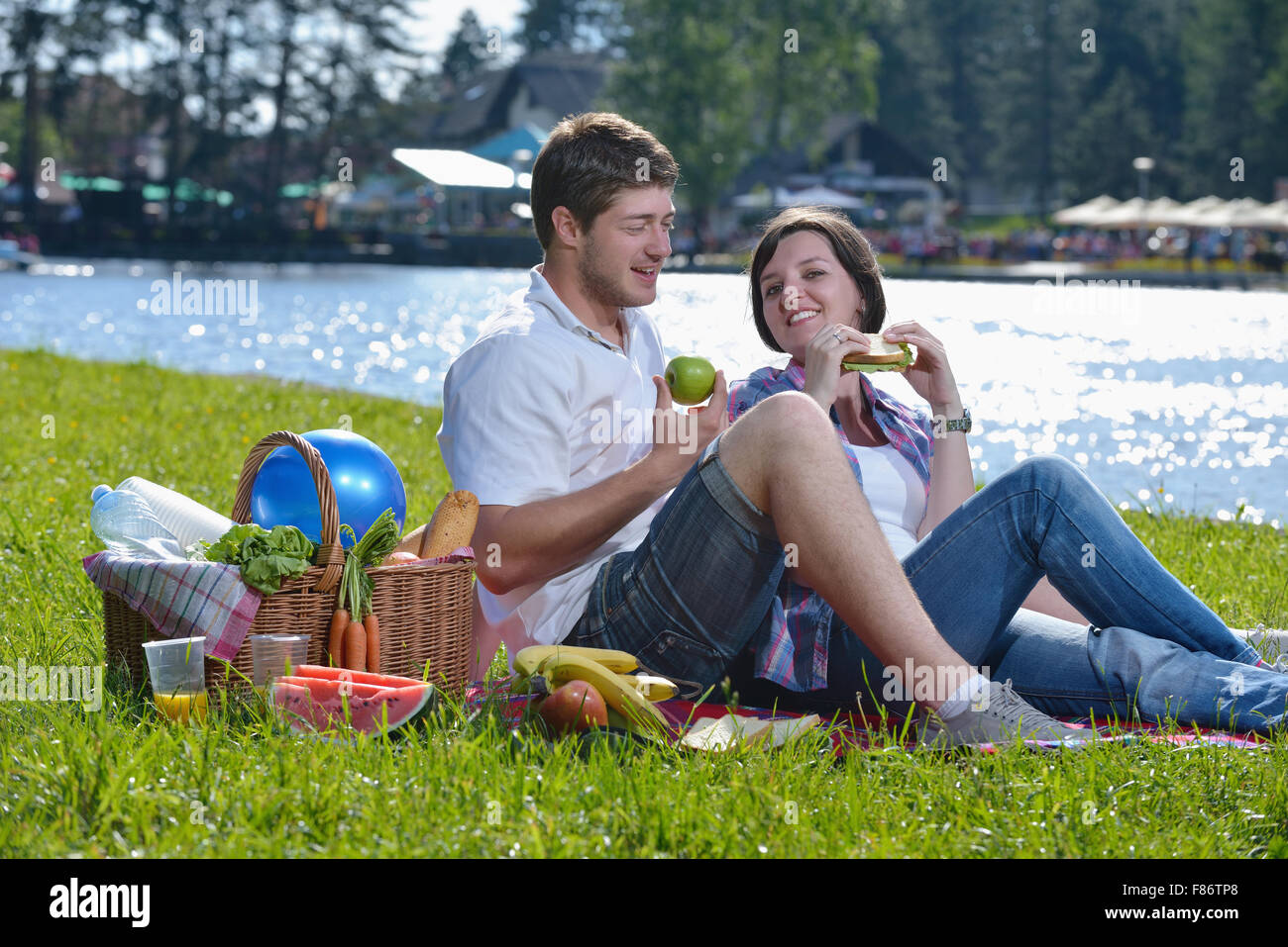 happy young romantic couple in love having a picnic outdoor on a summer ...