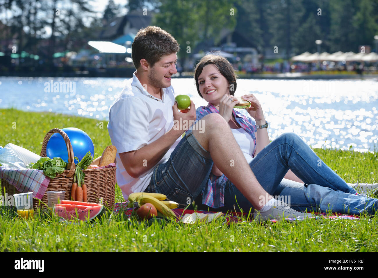 happy young romantic couple in love having a picnic outdoor on a summer ...