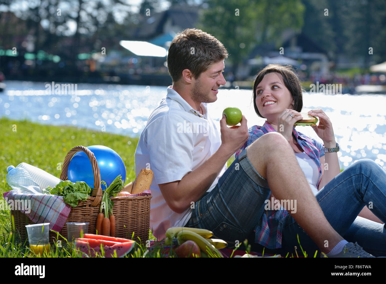 happy young romantic couple in love having a picnic outdoor on a summer ...