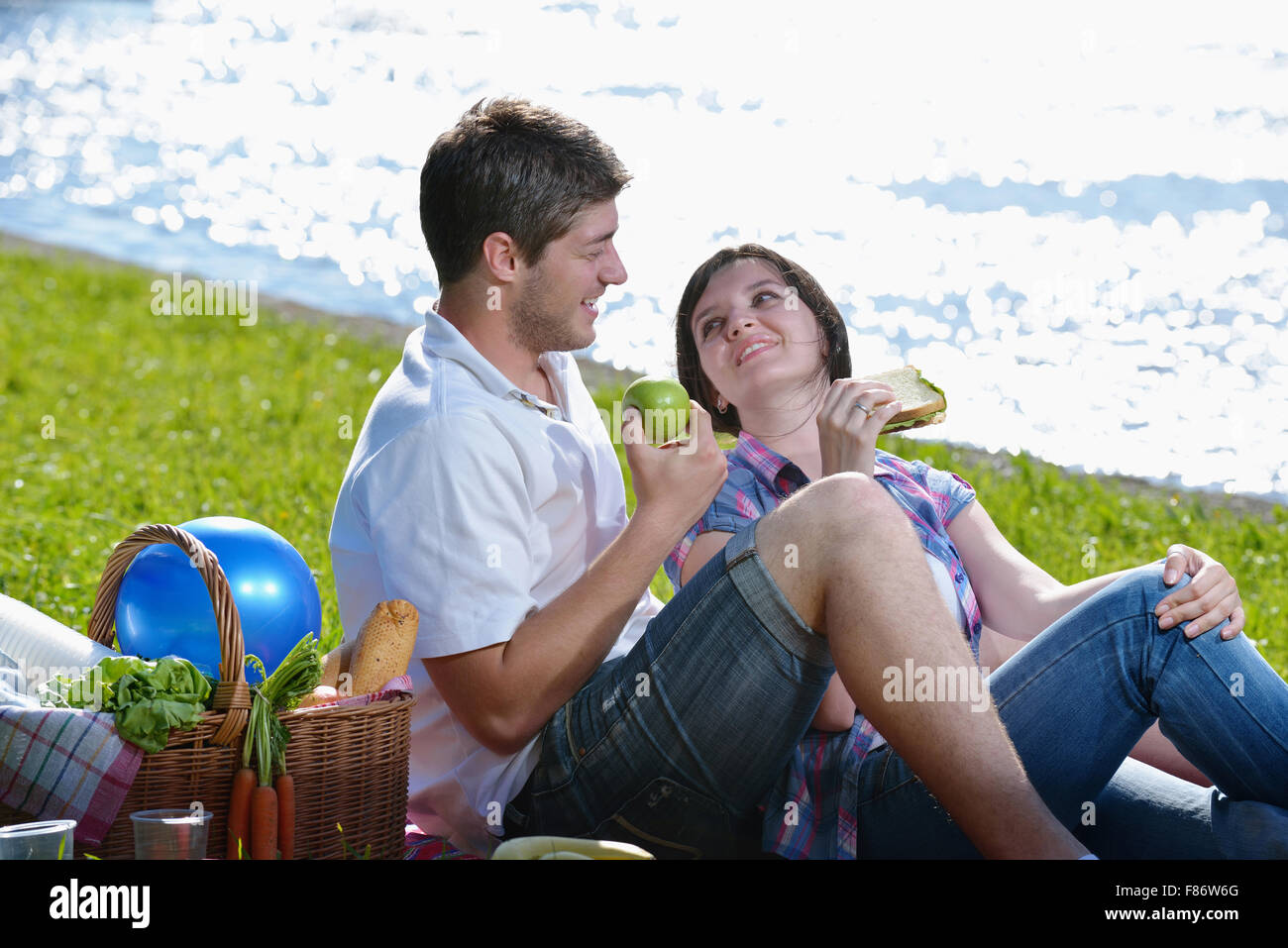 happy young romantic couple in love having a picnic outdoor on a summer ...