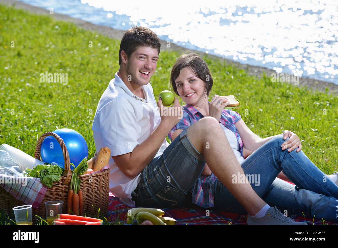 happy young romantic couple in love having a picnic outdoor on a summer ...