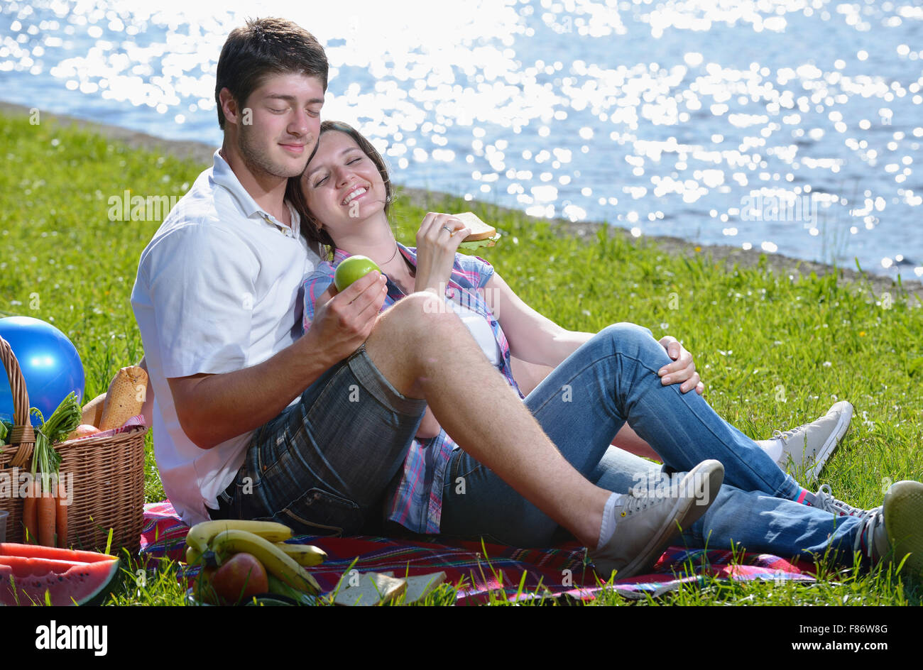 happy young romantic couple in love having a picnic outdoor on a summer ...