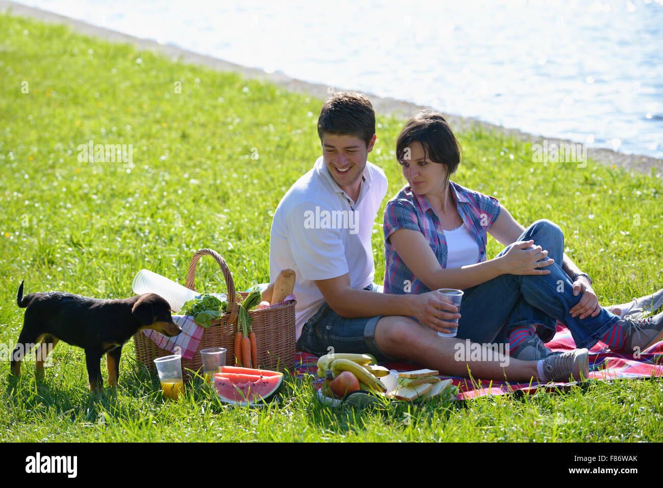happy young romantic couple in love having a picnic outdoor on a summer ...