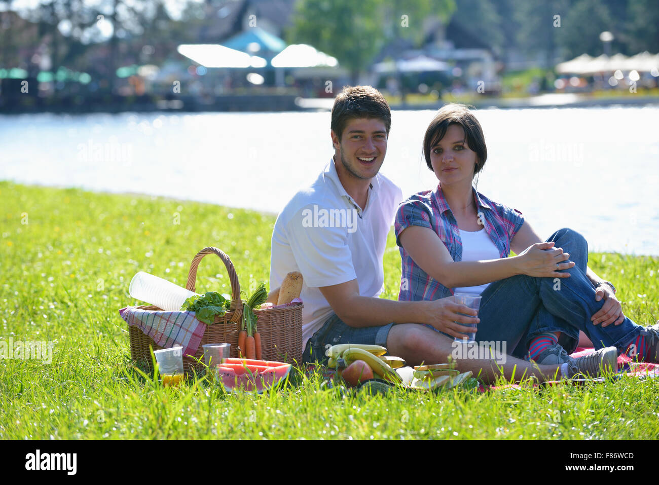 happy young romantic couple in love having a picnic outdoor on a summer ...