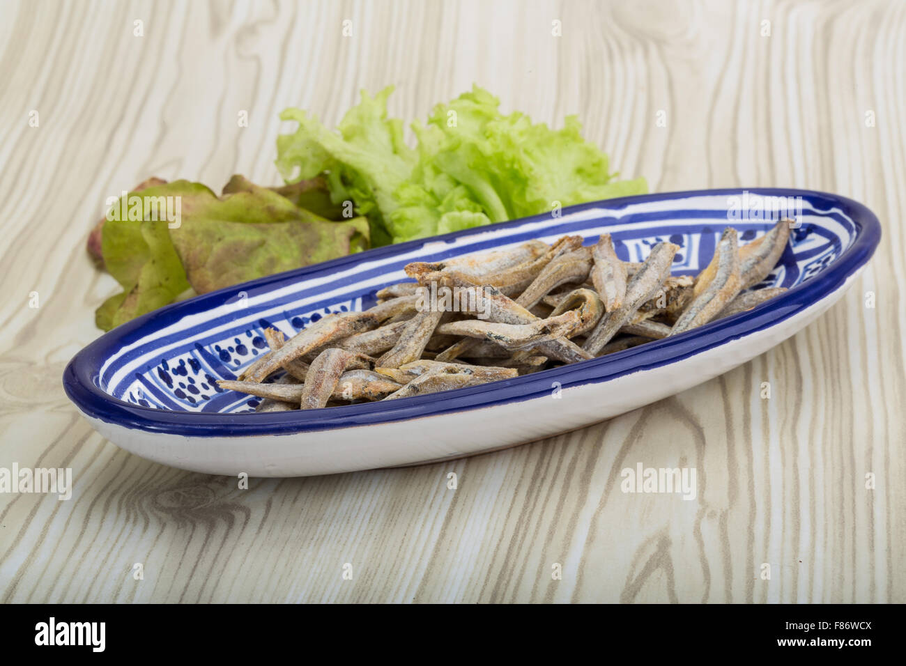 Dries anchovy - small fishes in the bowl Stock Photo - Alamy