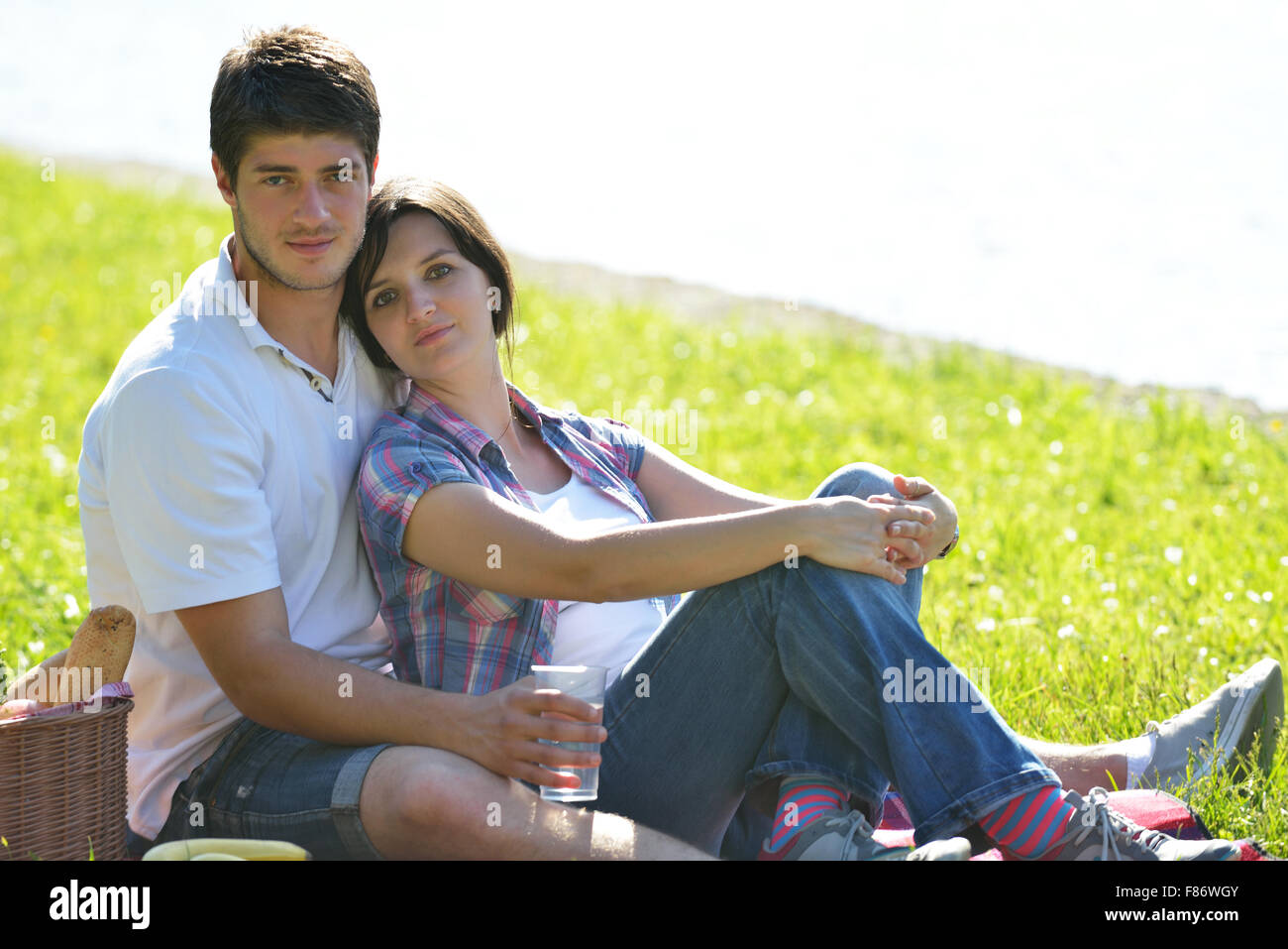 happy young romantic couple in love having a picnic outdoor on a summer ...