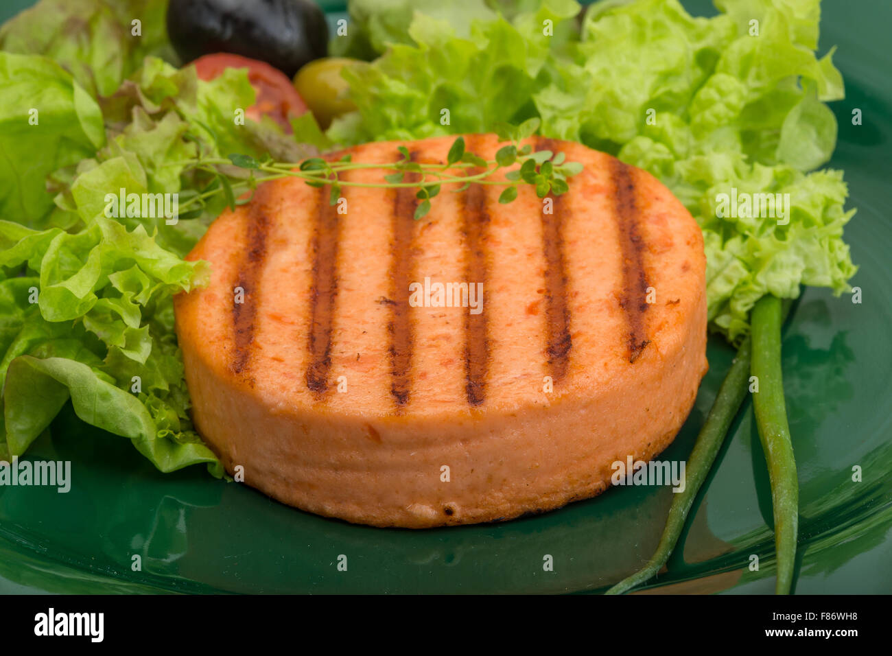 Grilled Fish cakes in the bowl with salad leaves Stock Photo - Alamy