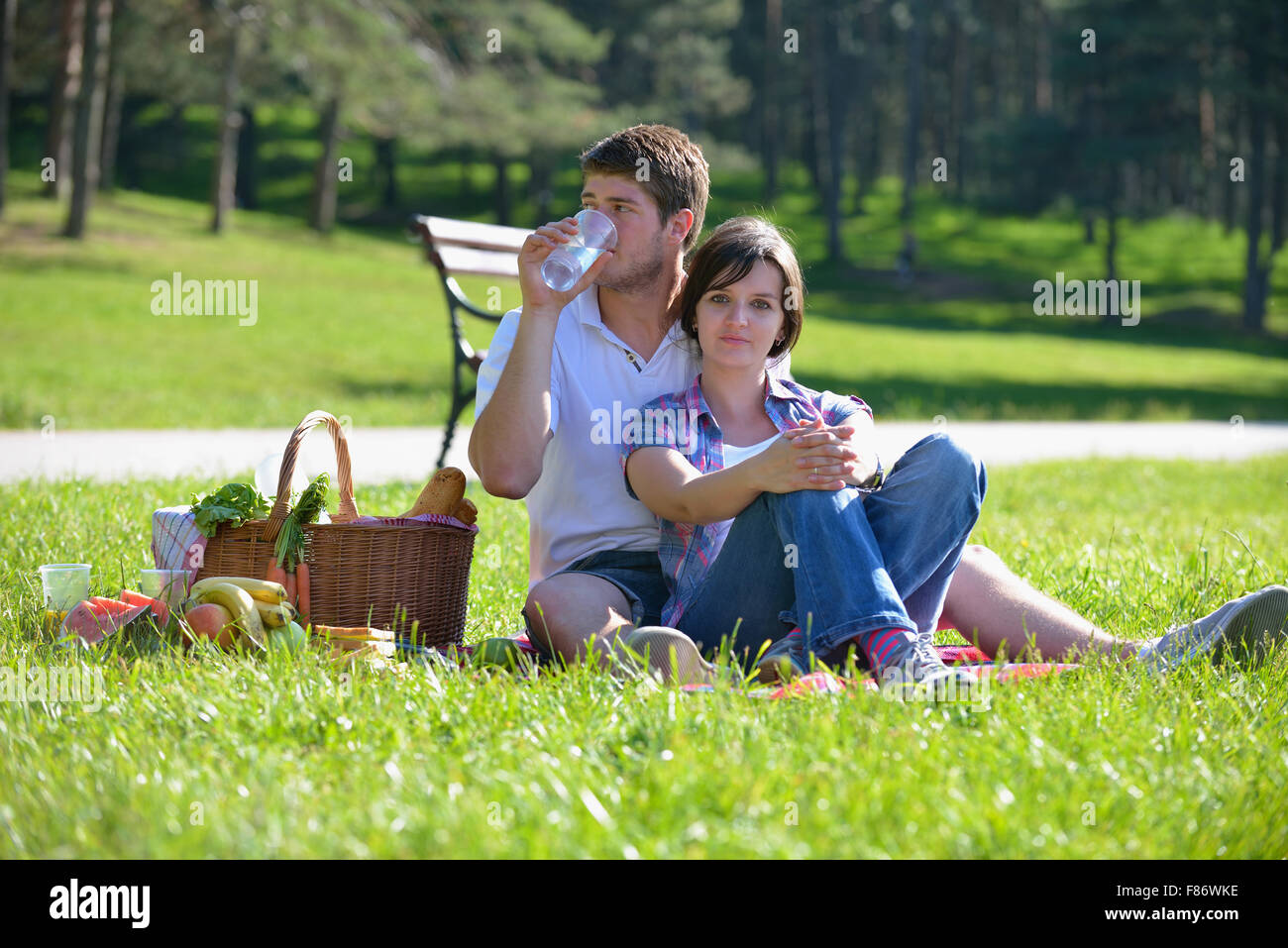 happy young romantic couple in love having a picnic outdoor on a summer ...