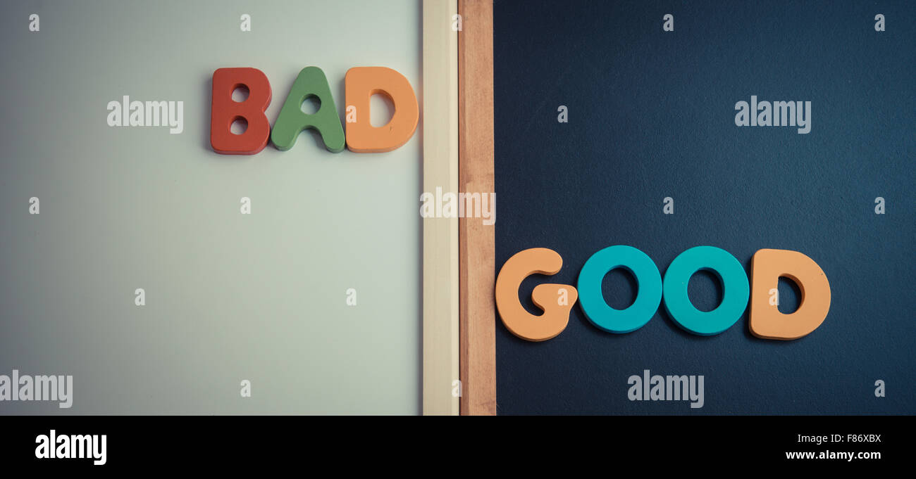 Wooden word BAD and GOOD on black board and white board in vintage ...