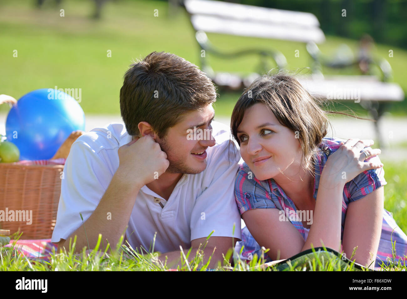 happy young romantic couple in love having a picnic outdoor on a summer ...