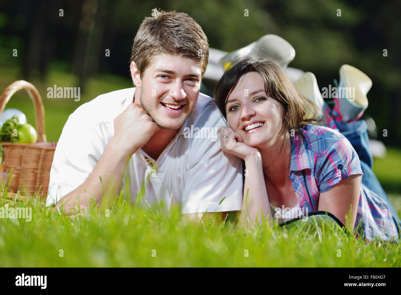 happy young romantic couple in love having a picnic outdoor on a summer ...