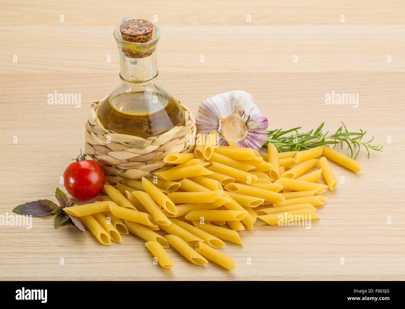 Penne - raw italian pasta with oil Stock Photo - Alamy