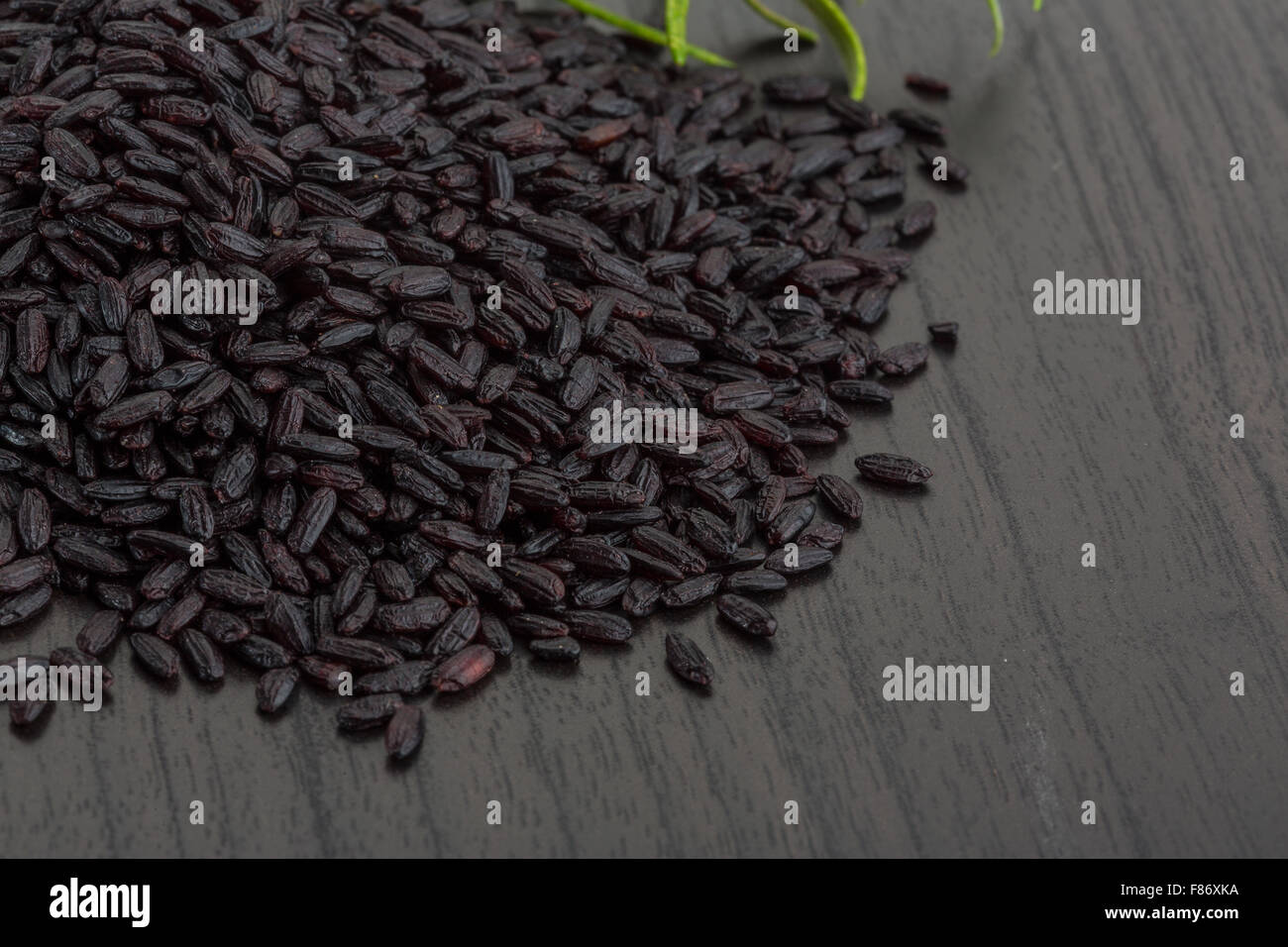 Raw black rice on the board Stock Photo - Alamy
