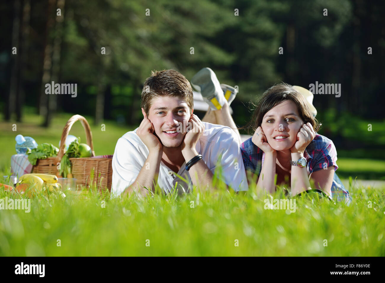 happy young romantic couple in love having a picnic outdoor on a summer ...