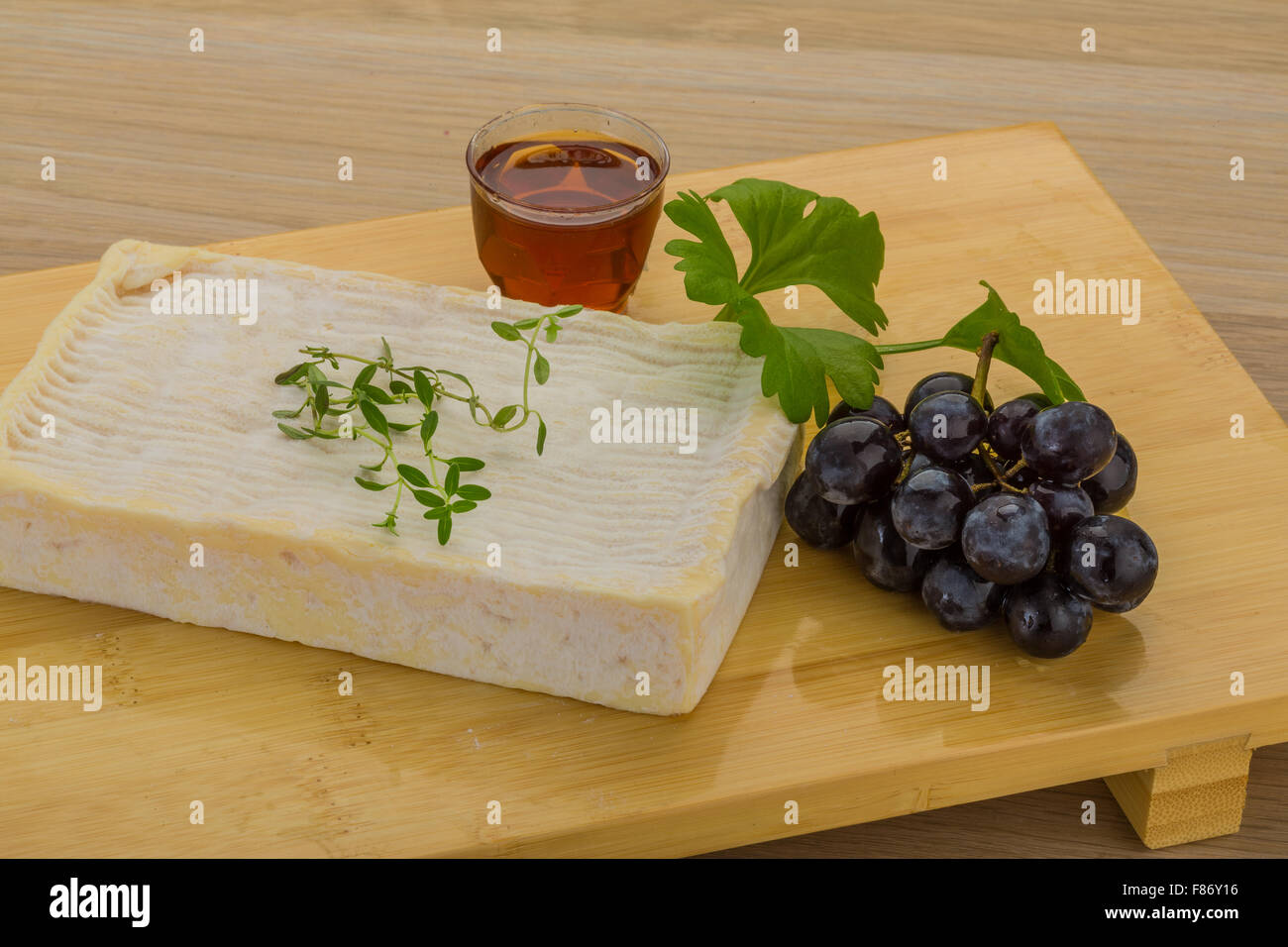 Brie cheese with thyme and grape Stock Photo - Alamy