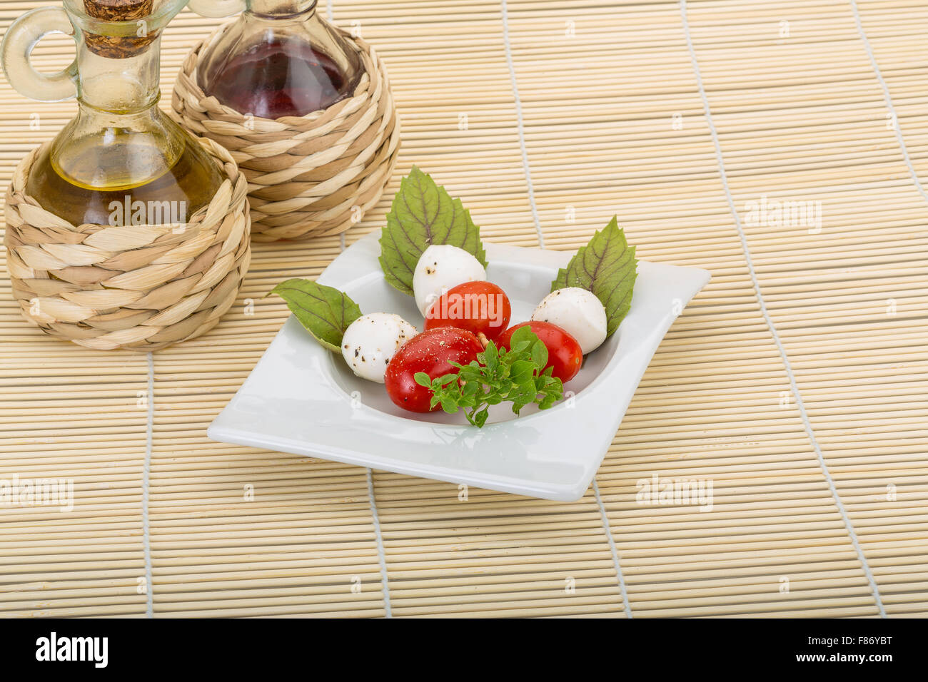 Famous italian caprese salad with fresh basil leaves Stock Photo - Alamy