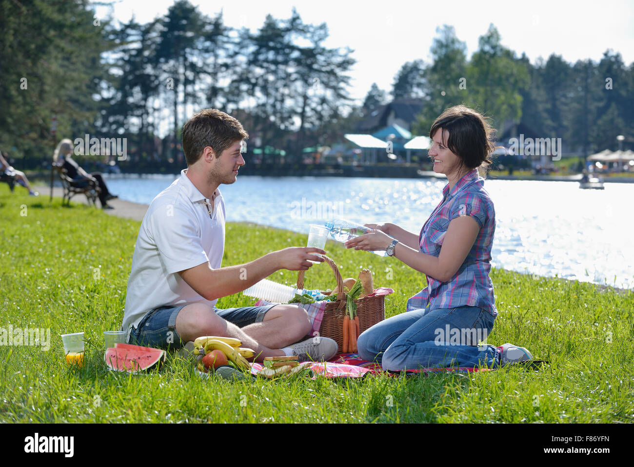 happy young romantic couple in love having a picnic outdoor on a summer ...