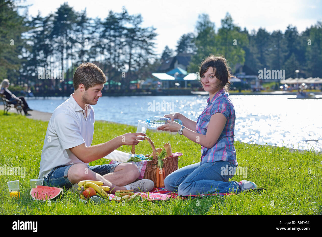 happy young romantic couple in love having a picnic outdoor on a summer ...