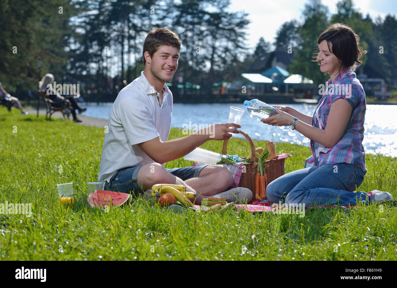 happy young romantic couple in love having a picnic outdoor on a summer ...