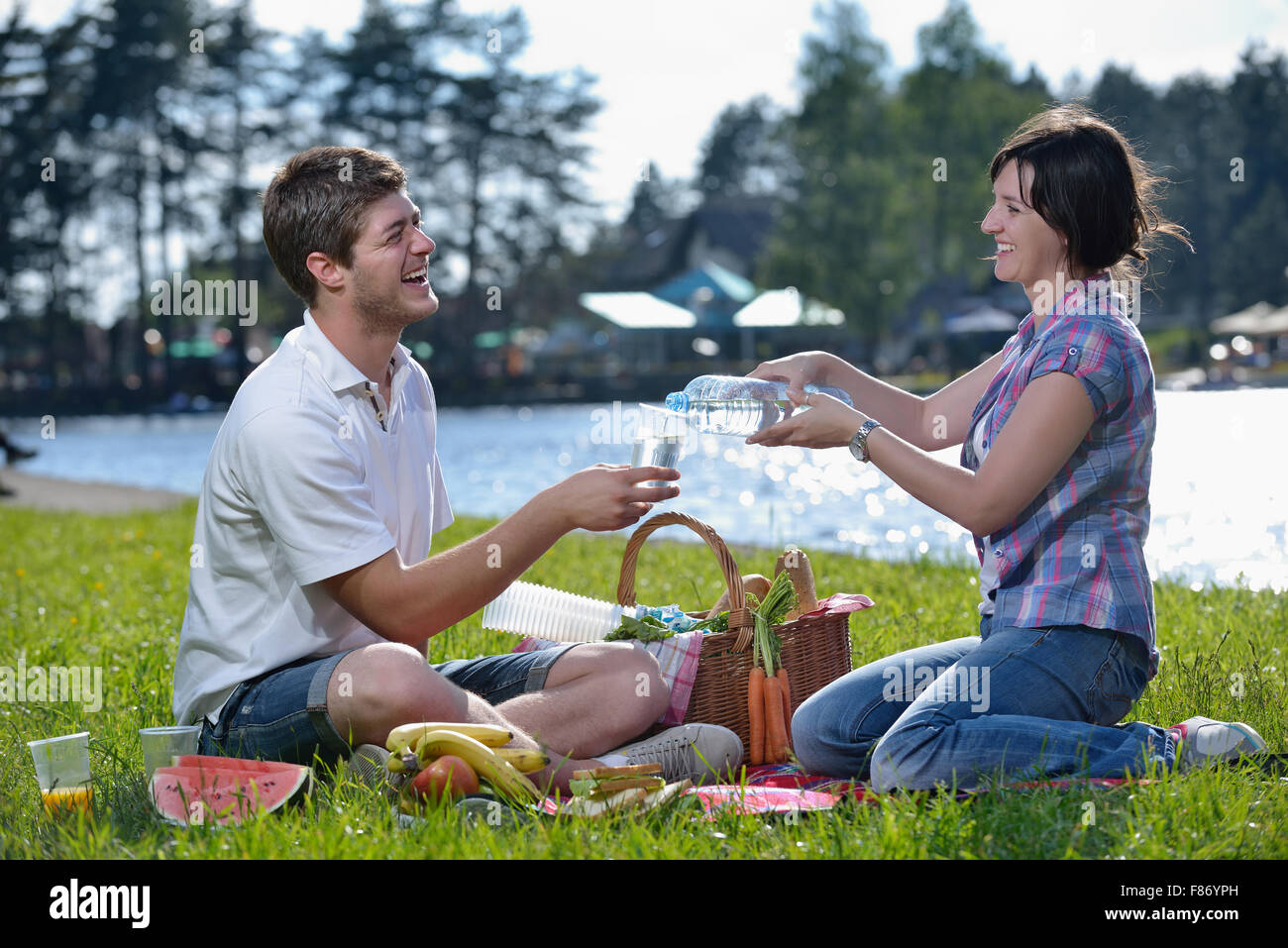 happy young romantic couple in love having a picnic outdoor on a summer ...
