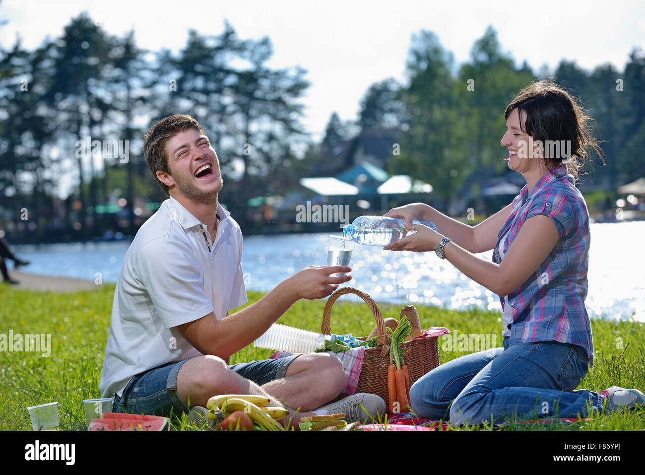 happy young romantic couple in love having a picnic outdoor on a summer ...