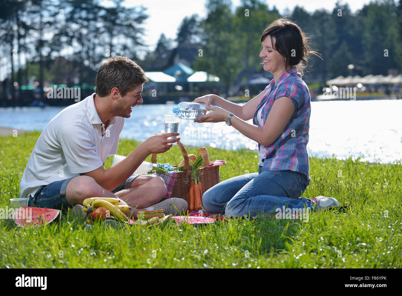 happy young romantic couple in love having a picnic outdoor on a summer ...