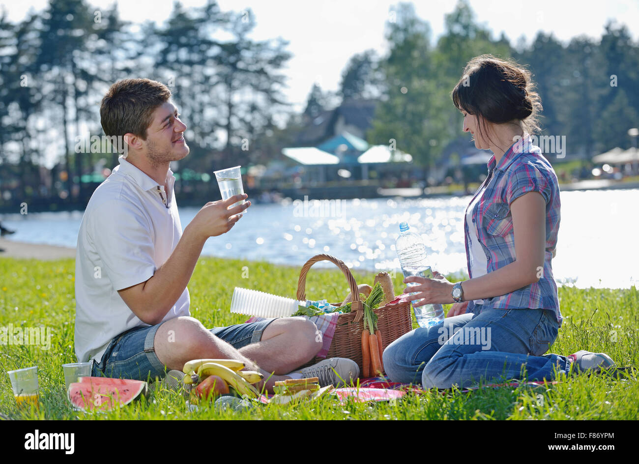 happy young romantic couple in love having a picnic outdoor on a summer ...