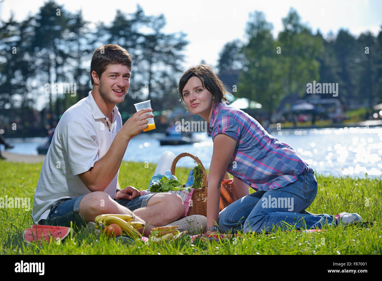 happy young romantic couple in love having a picnic outdoor on a summer ...