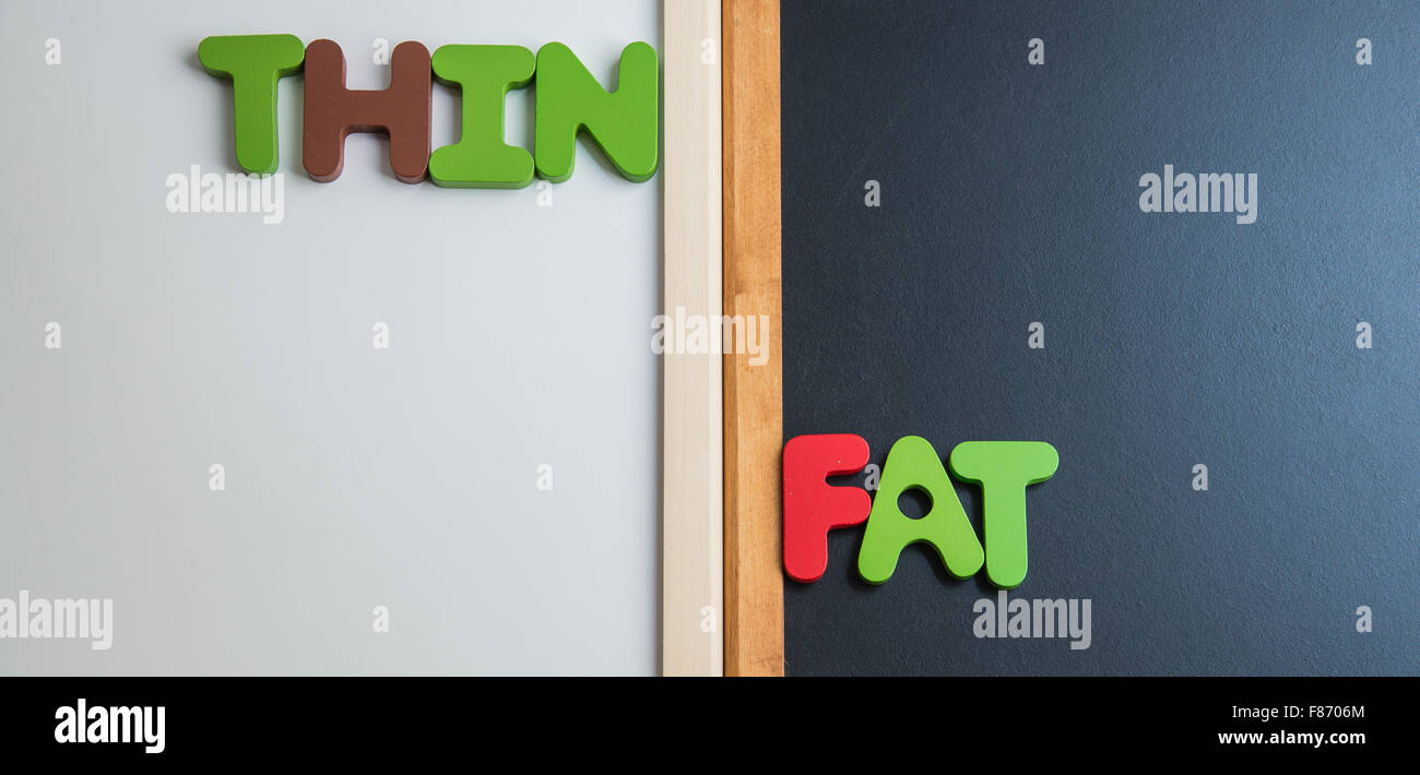 Wooden word THIN and FAT on black board and white board Stock Photo - Alamy