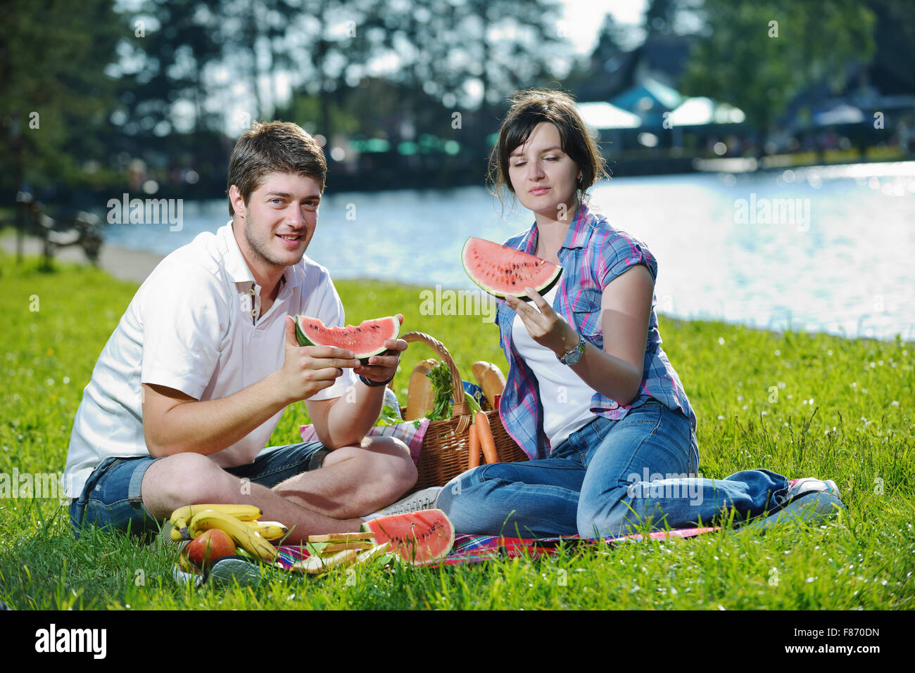 happy young romantic couple in love having a picnic outdoor on a summer ...