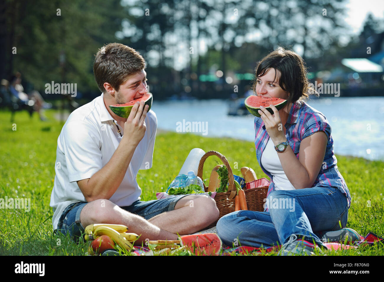 happy young romantic couple in love having a picnic outdoor on a summer ...