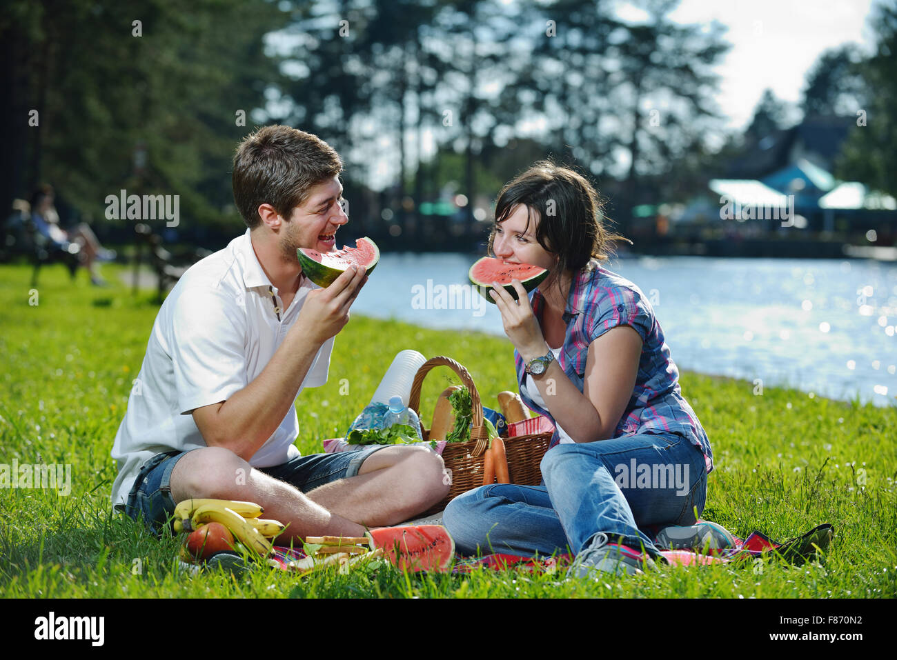 happy young romantic couple in love having a picnic outdoor on a summer ...