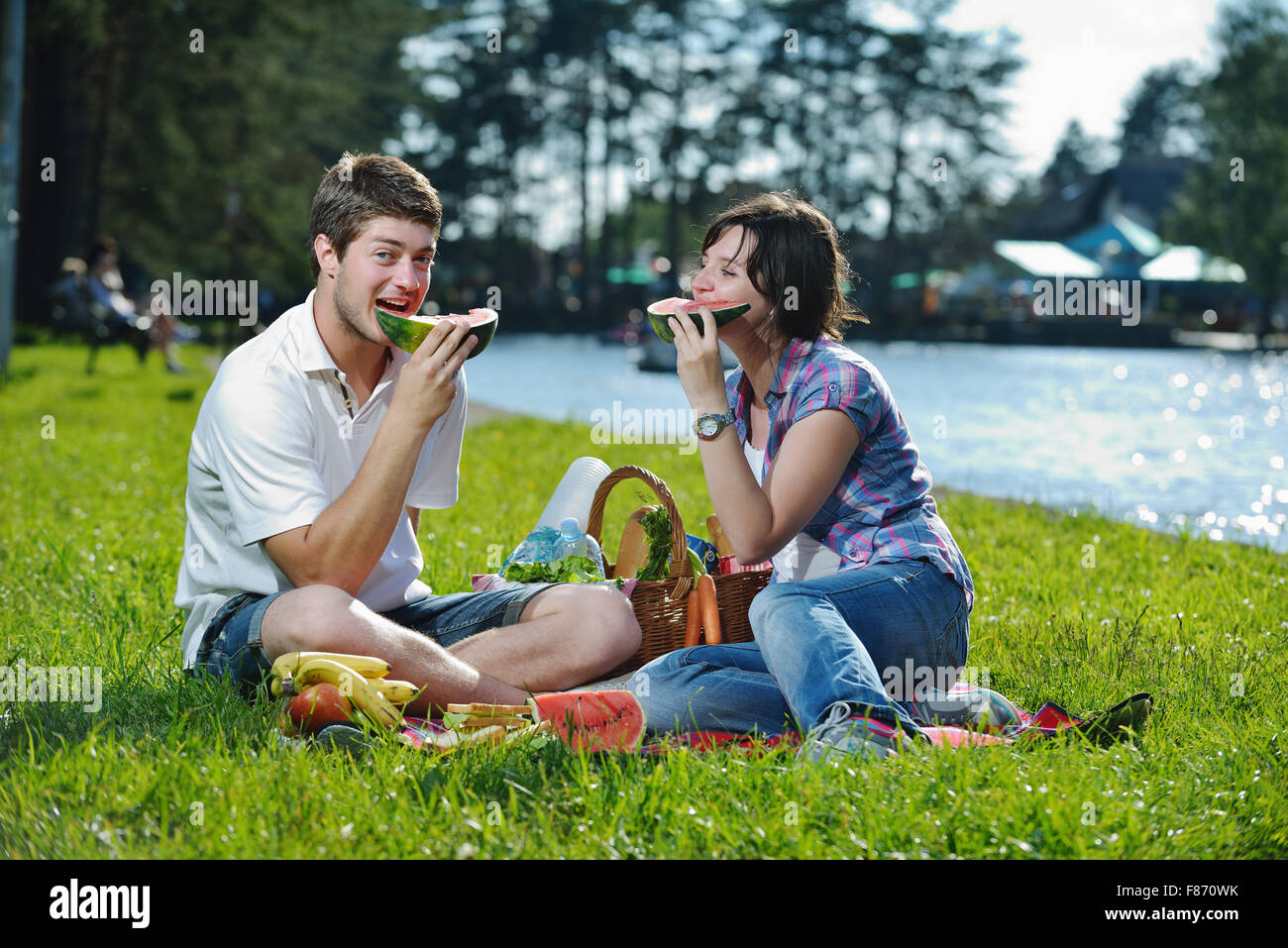 happy young romantic couple in love having a picnic outdoor on a summer ...