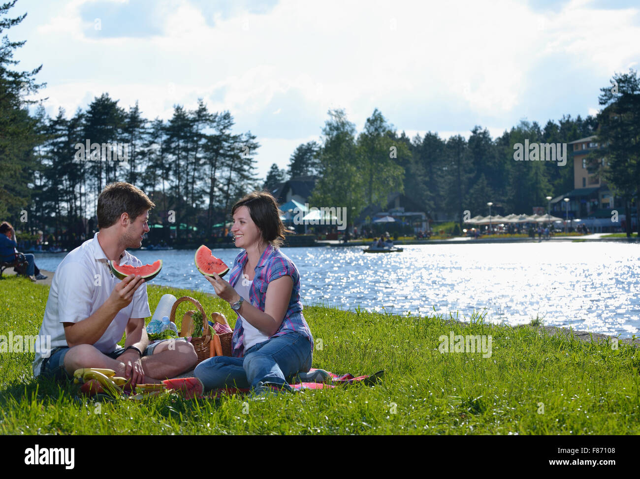 happy young romantic couple in love having a picnic outdoor on a summer ...
