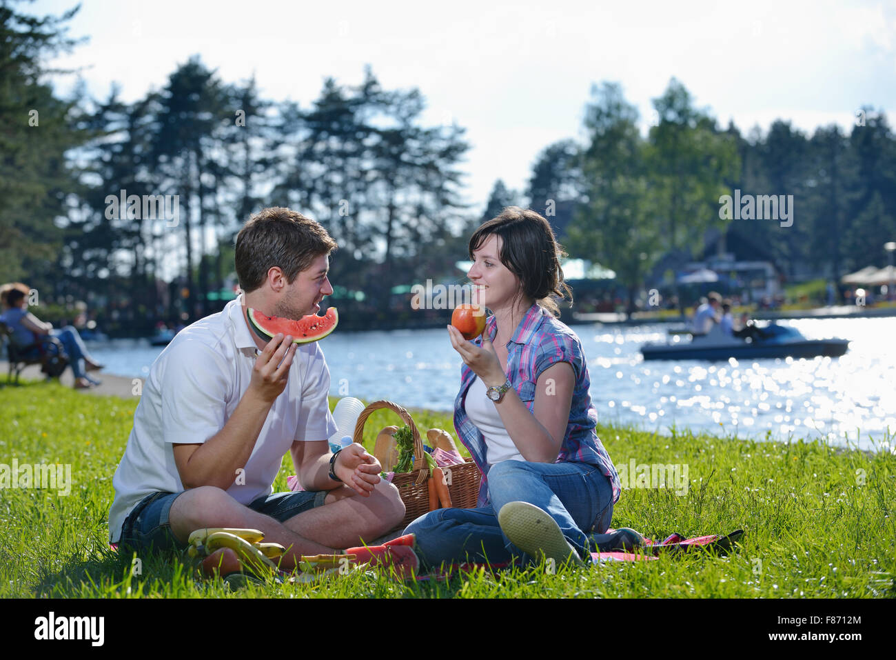 happy young romantic couple in love having a picnic outdoor on a summer ...