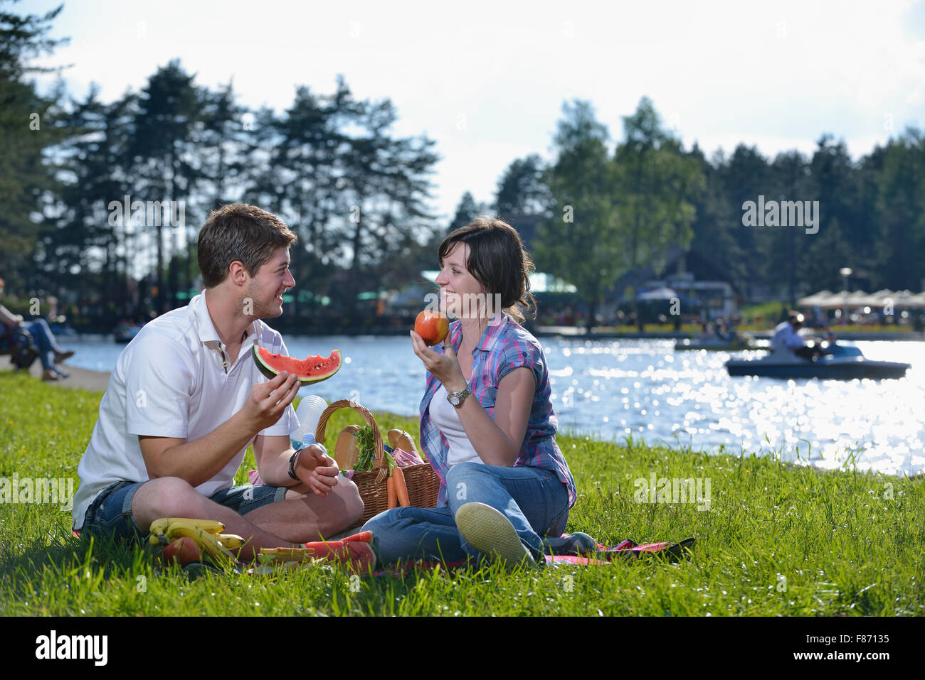 happy young romantic couple in love having a picnic outdoor on a summer ...