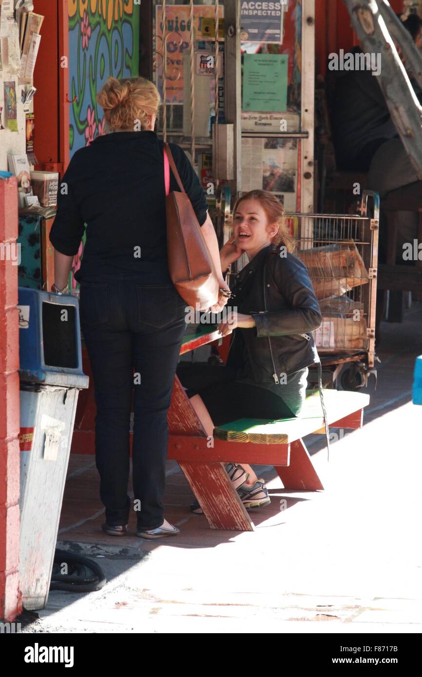 Isla Fisher having coffee with her friend outside a cute deli Featuring ...