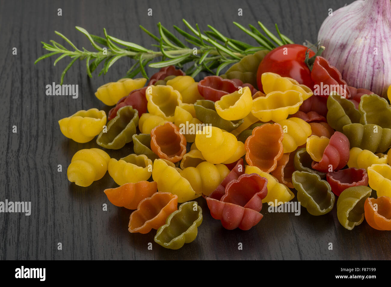 Raw shell pasta with herbs Stock Photo - Alamy