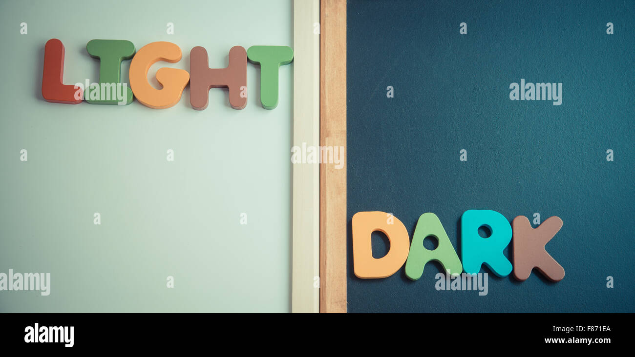 Wooden word LIGHT and DARK on black board and white board in vintage ...