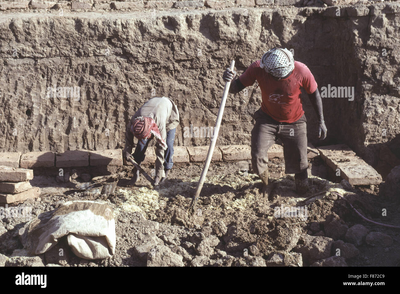 Laborers reconstructing walls of the ancient royal Palace at Nimrud ...
