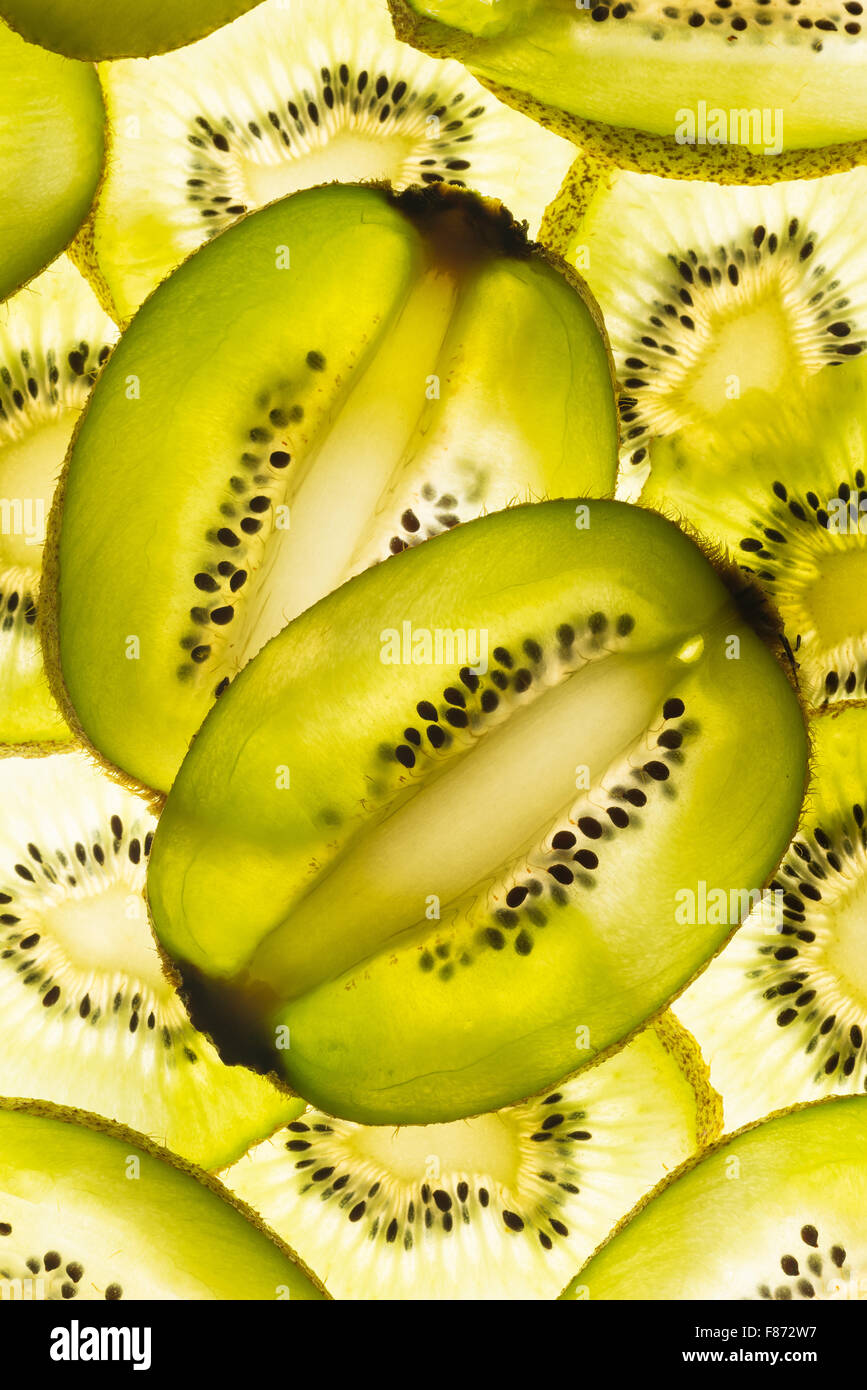 exotic kiwi fruit backlit in studio cut cross and longitudinal sections ...
