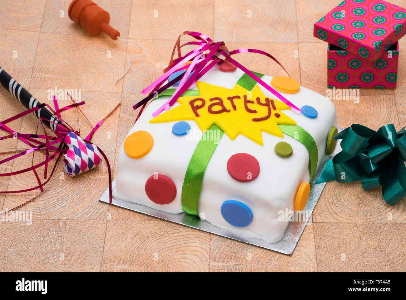 A party celebration cake with various party items Stock Photo - Alamy